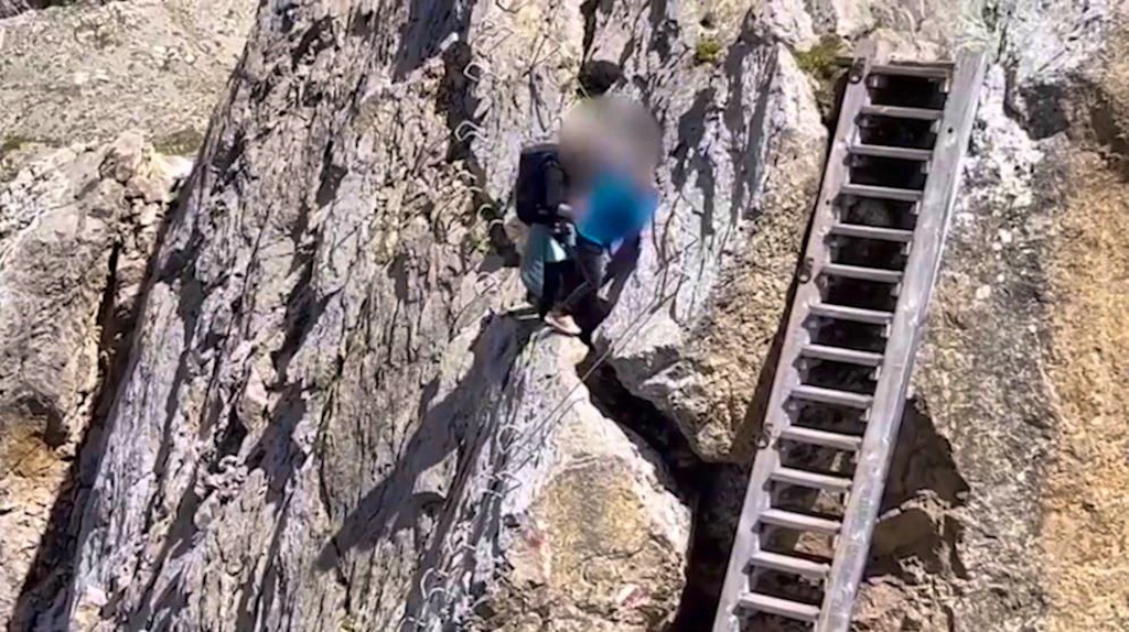 Parents climbing through the Dolomites - with a toddler in their arms